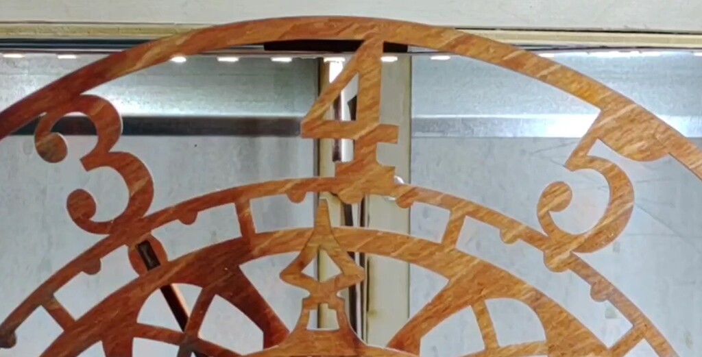 No clock hands, the dial/clock face turn counter clockwise behind a a ...